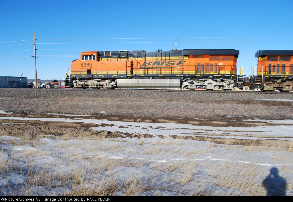 BNSF 6369 and BNSF 5833 pass me by as they pull west.